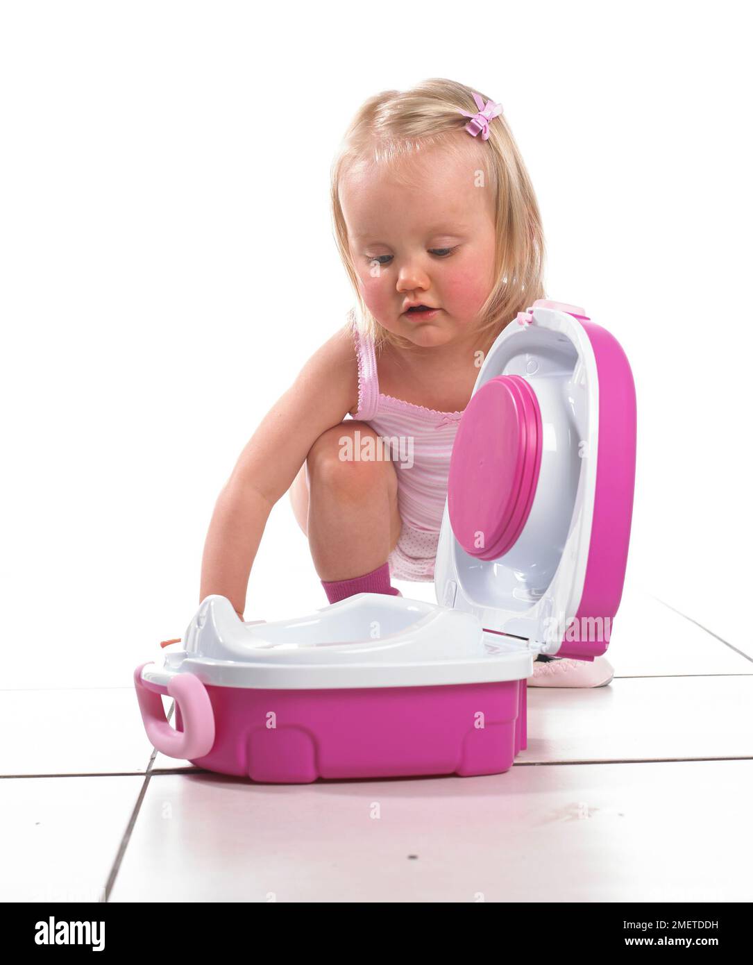 Girl wearing vest opening a portable potty, 20 months Stock Photo - Alamy