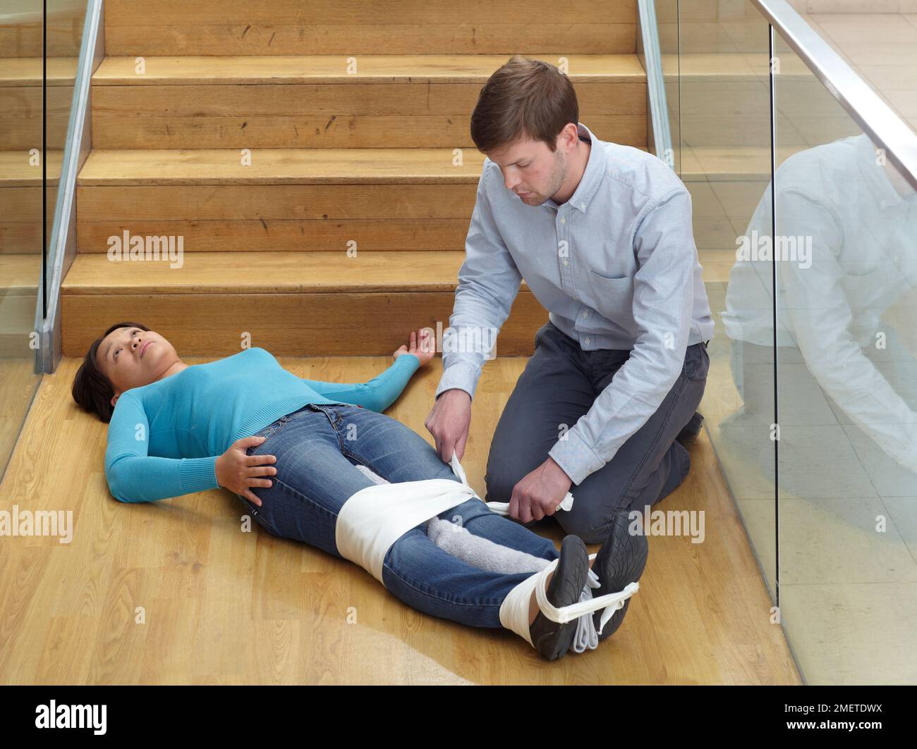 First aid pelvic injury or fractured pelvis treatment, bandaging legs ...