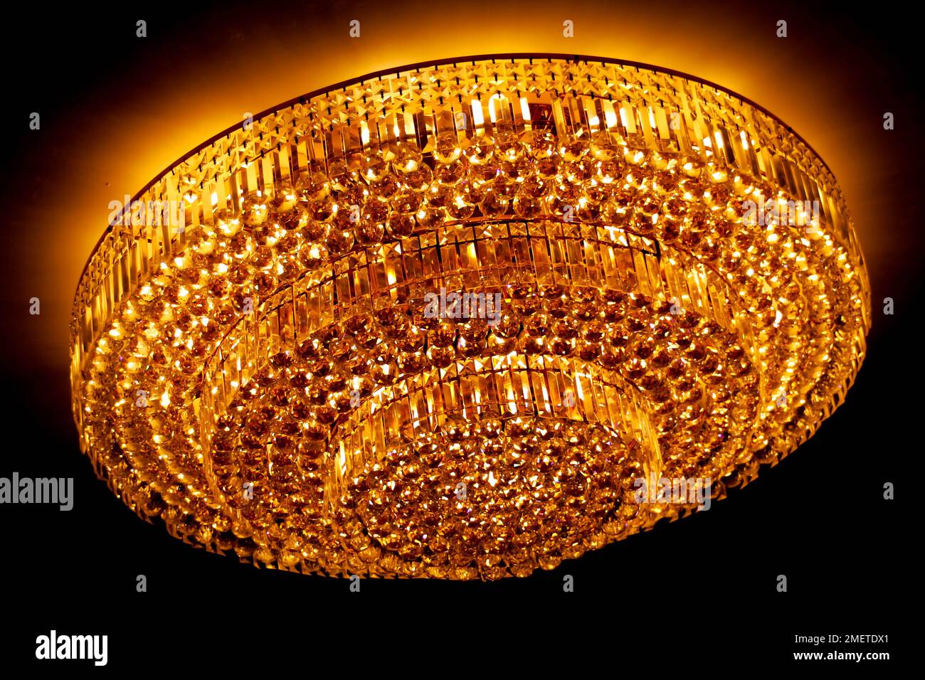 A closeup of illuminated crystal chandelier on black background Stock ...
