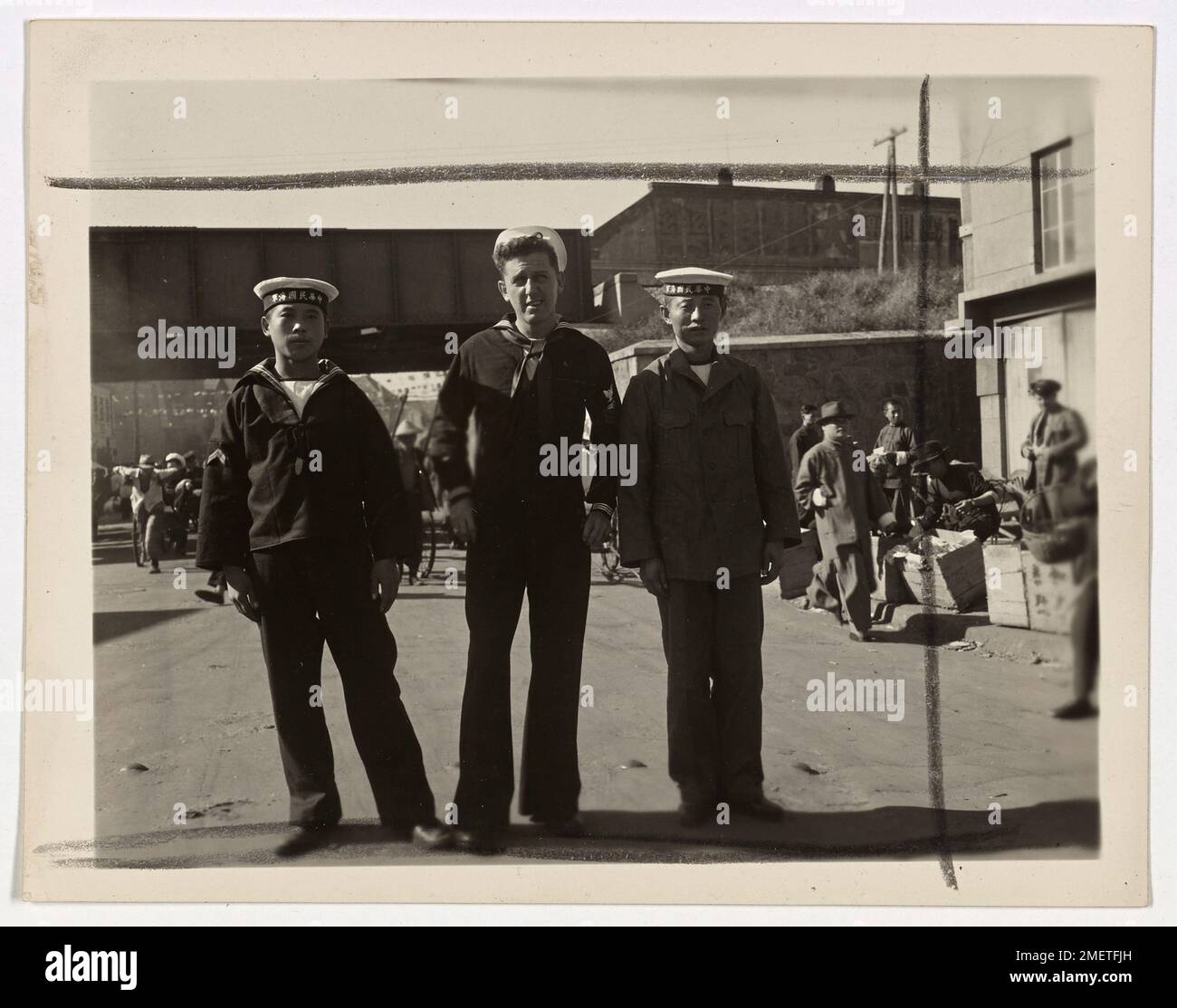 A photograph shows a Seabee with sailors of the Republic of China Navy ...