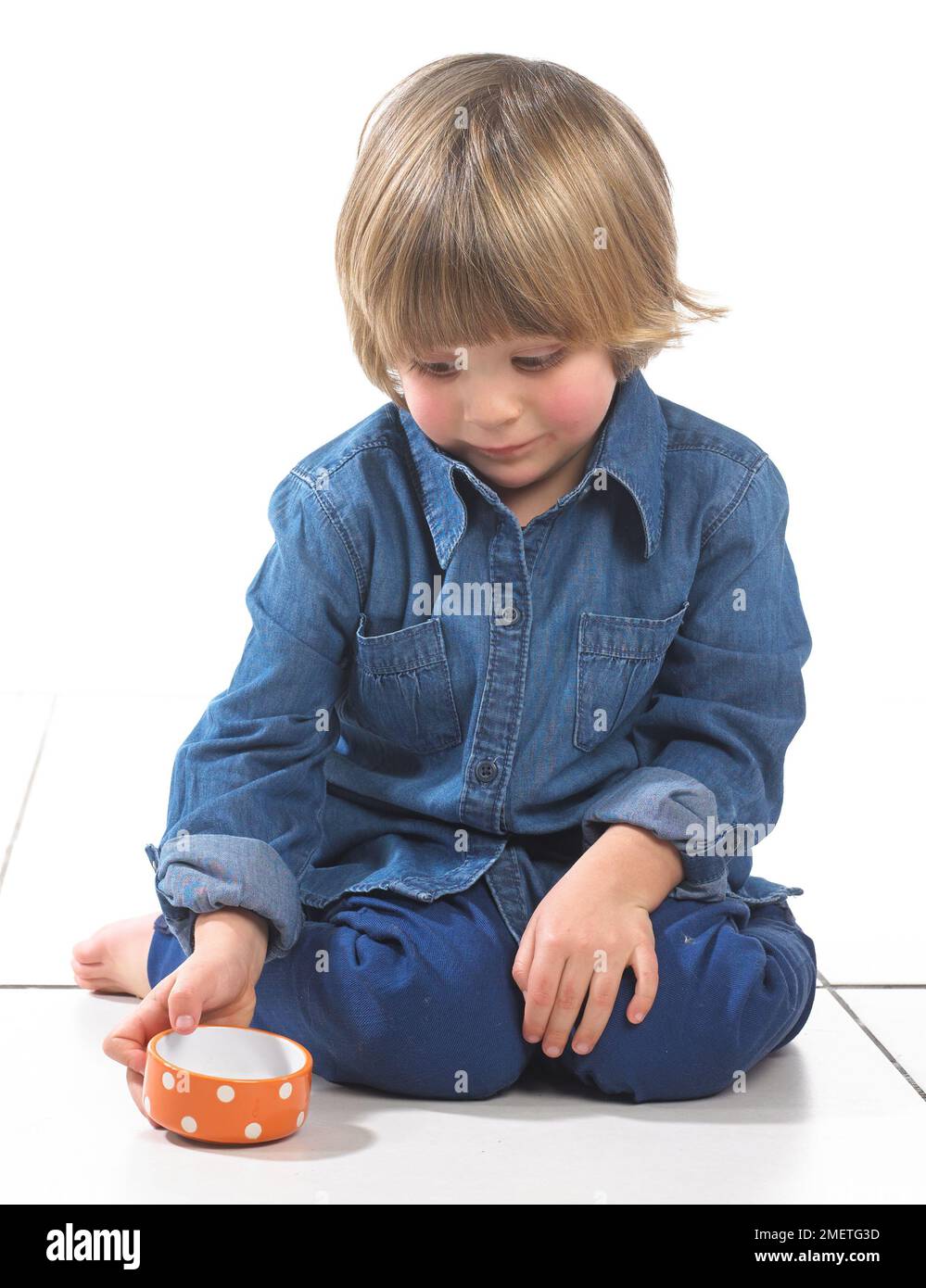 Boy sitting holding small pet feeding bowl, 3 years Stock Photo - Alamy