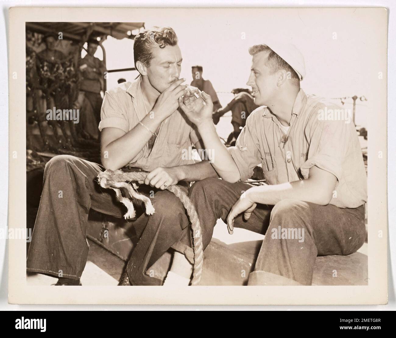 Actor Cesar Romero is photographed with a fellow Coast Guardsman ...
