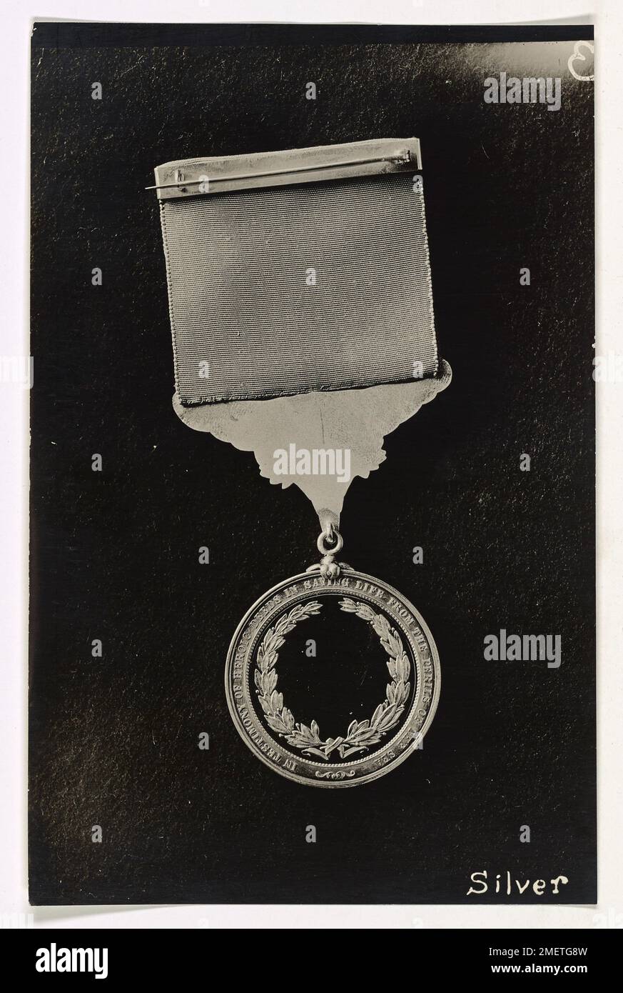 The reverse side of the Silver Life-Saving Medal, awarded by Congress ...