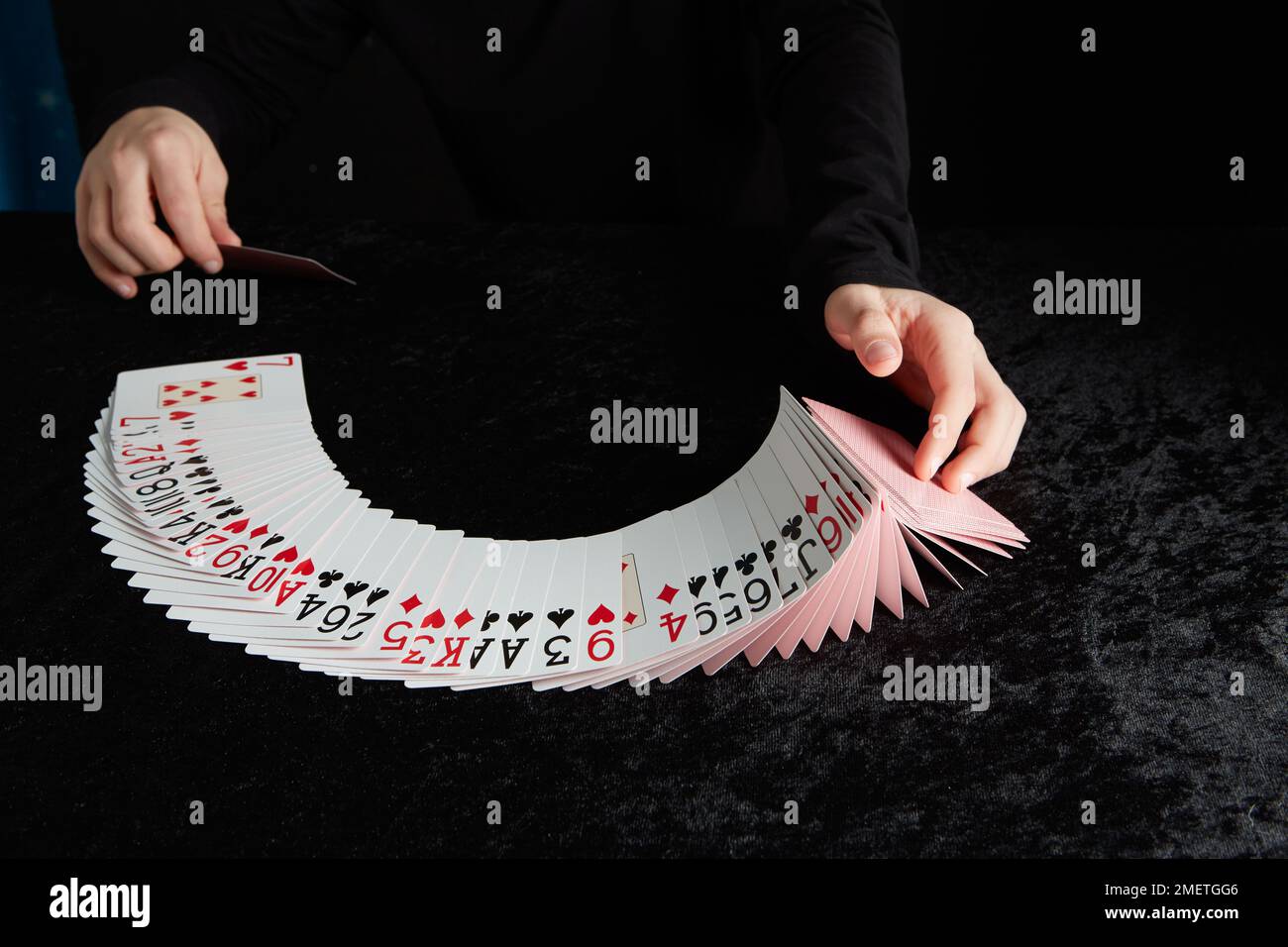 Child performing card trick Stock Photo - Alamy