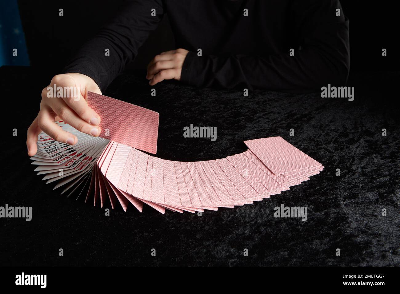 Child performing card trick Stock Photo - Alamy