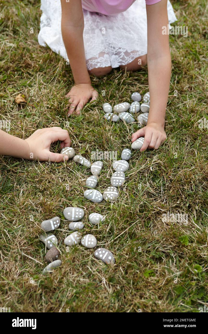 Grass pebble hand hi-res stock photography and images - Alamy