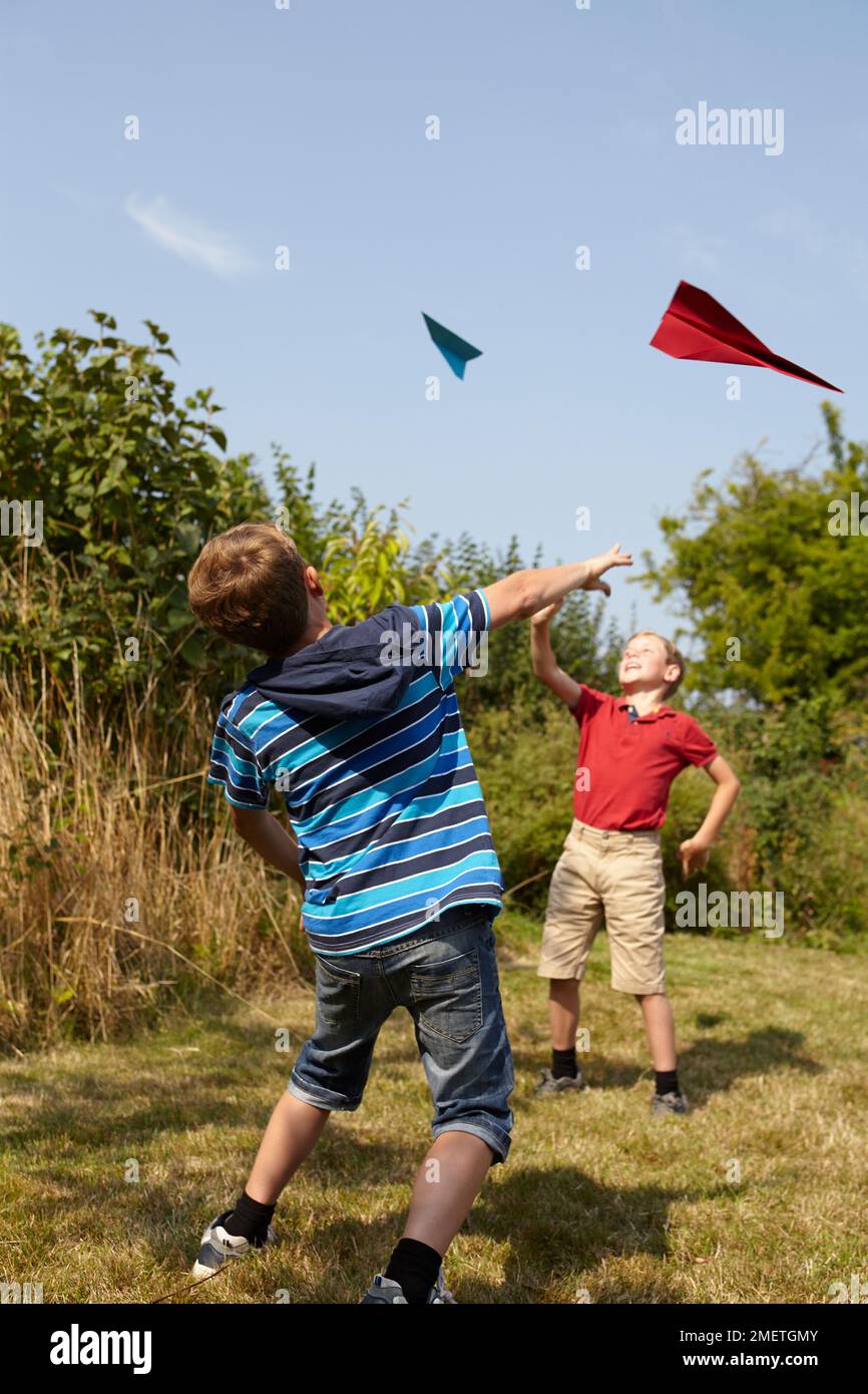 Boys playing with paper airplane Stock Photo - Alamy