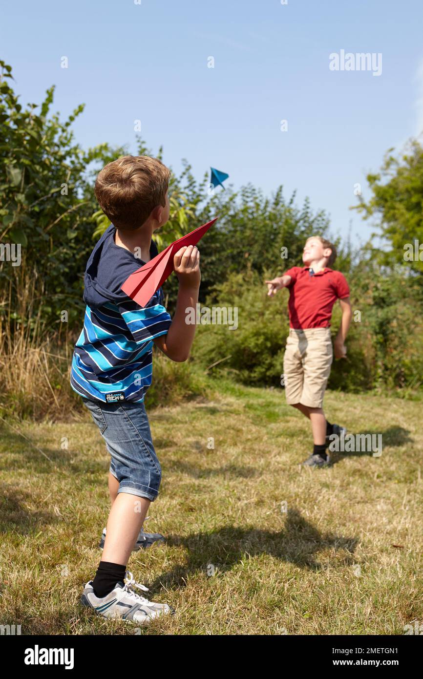 Boys playing with paper airplane Stock Photo - Alamy