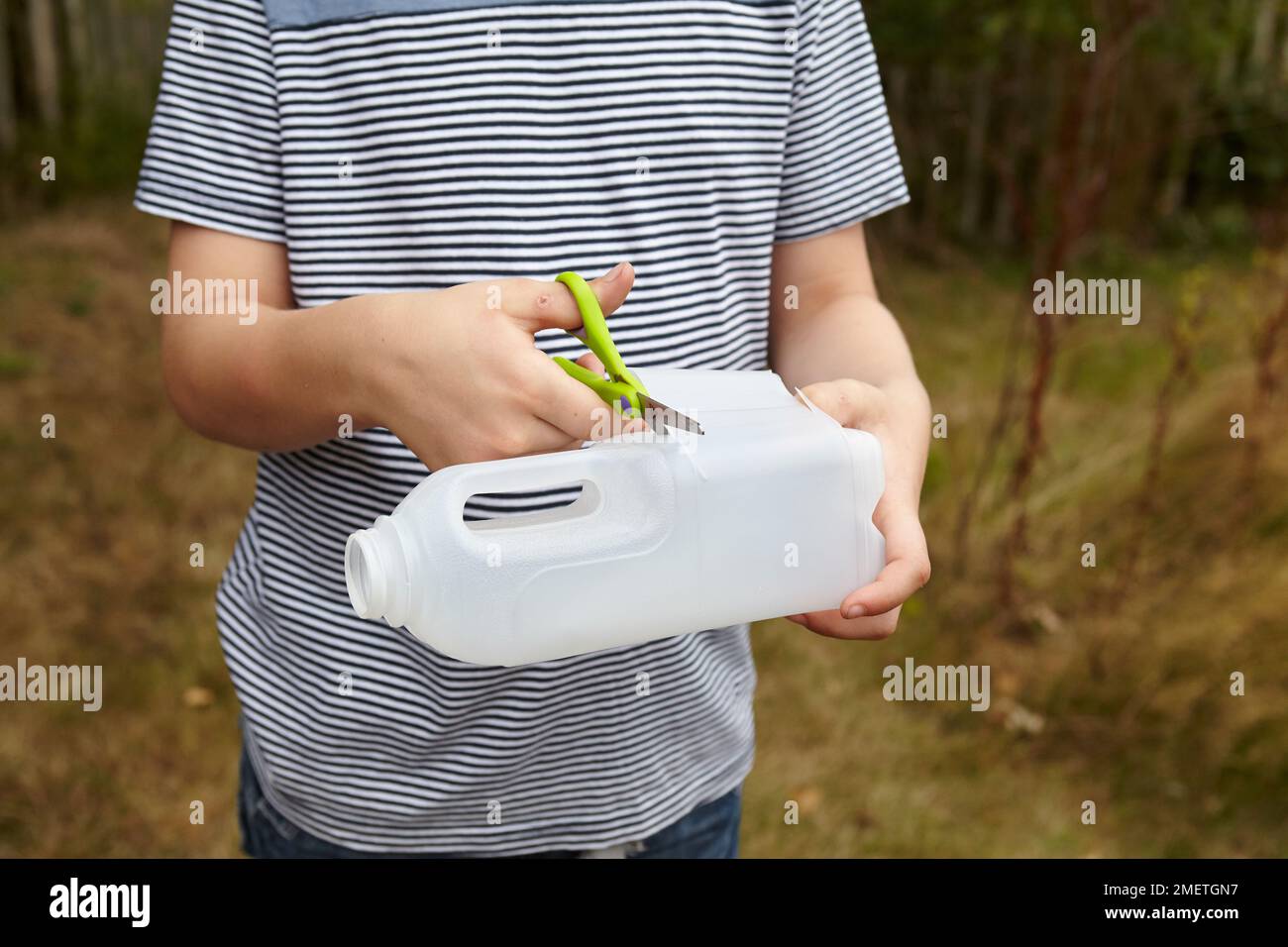 Cutting open plastic milk bottle Stock Photo - Alamy