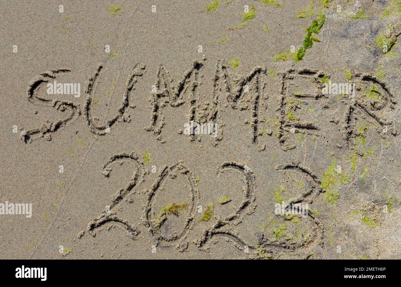 The inscription on the sand Summer 2023 symbolizes a summer vacation at ...