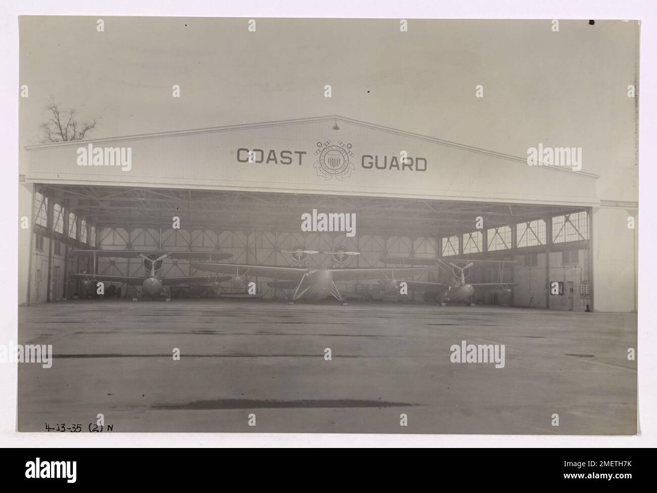 This photograph shows a U.S. Coast Guard airplane hangar, where ...