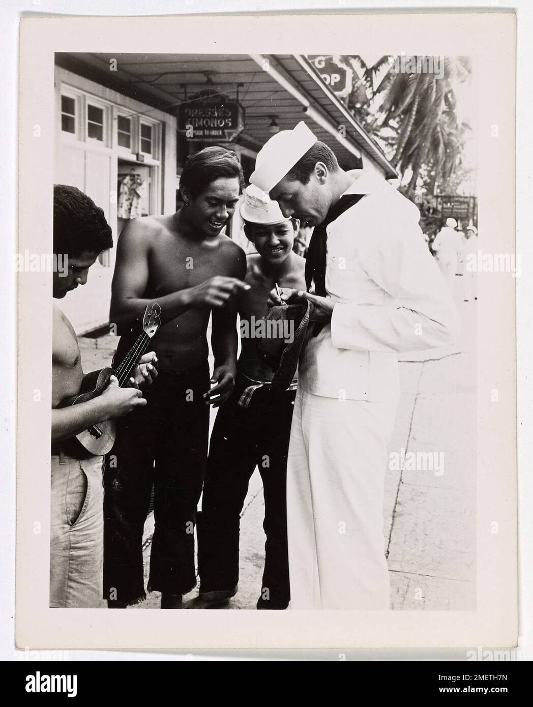 Cesar Romero, a famous actor, is pictured signing an autograph ...