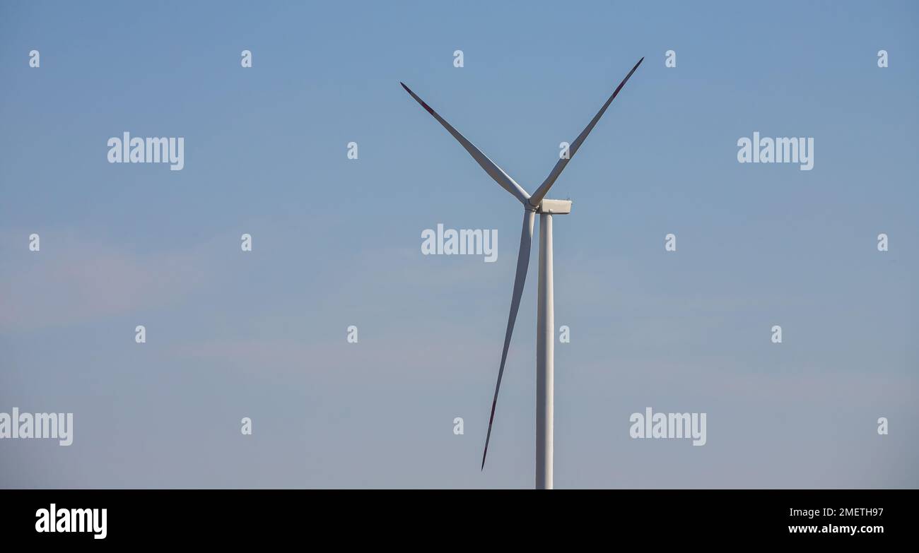 wind mill or also wind-turbine on wind farm in rotation to generate ...