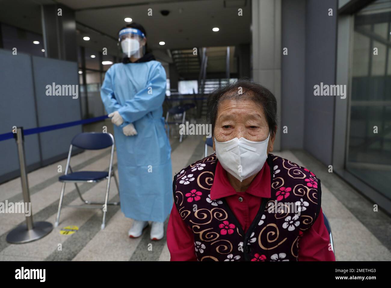 A South Korean elderly woman waits to receive the first dose of the ...