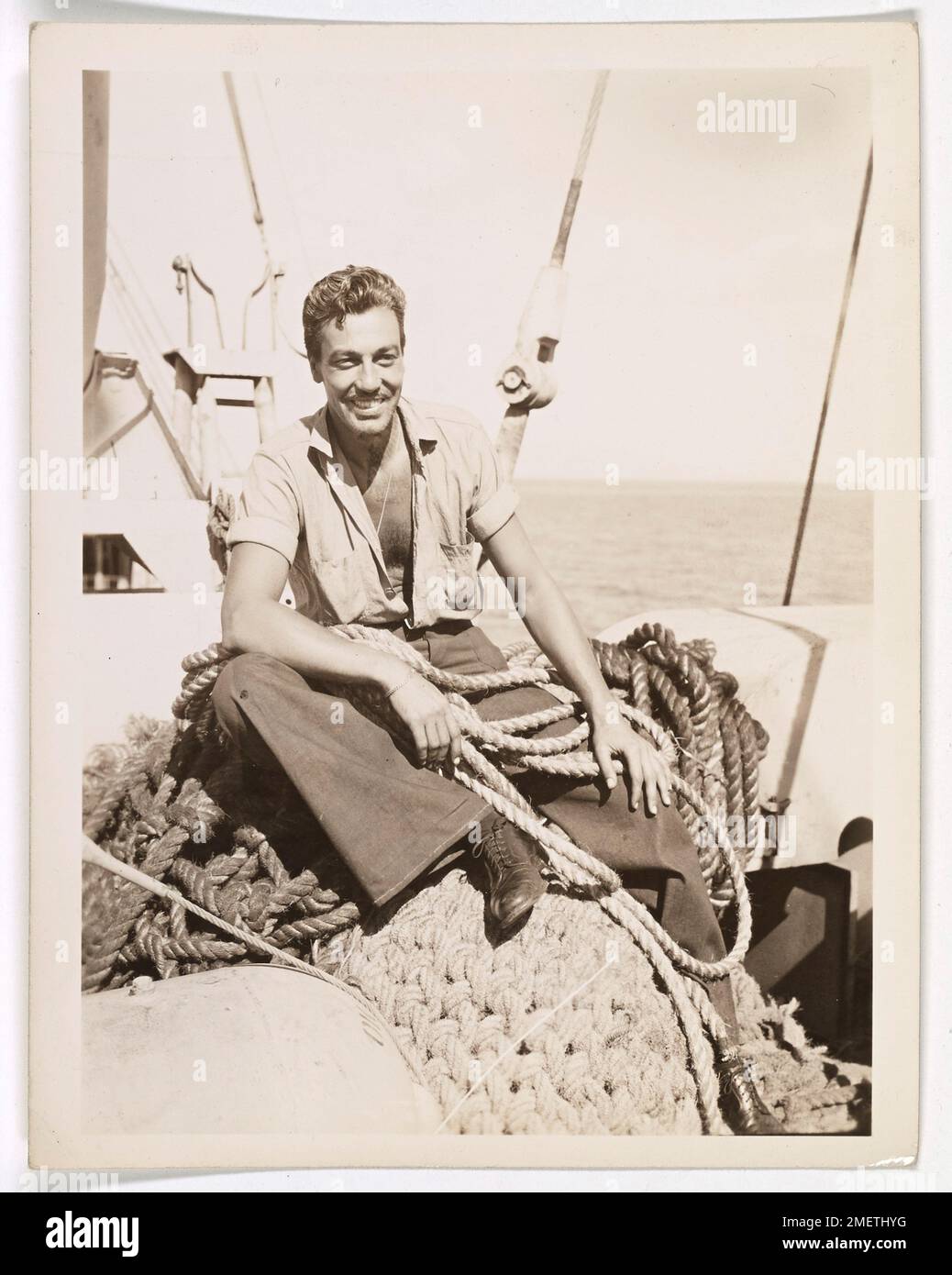 A photograph captures actor Cesar Romero aboard a Coast Guard-manned ...