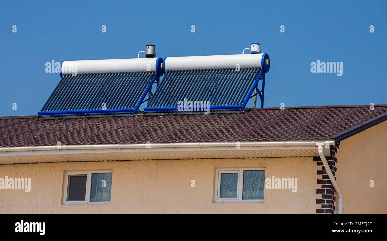 Solar water heater on roof top, beautiful blue sky background Stock ...