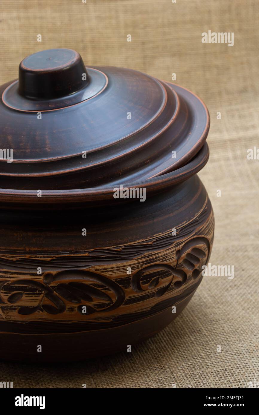 Ceramic tableware in orange-brown color with a white pattern on the ...