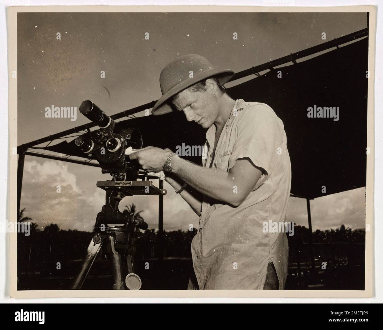 Larison M. Sater, a Coast Guard combat photographer, cleans his camera ...