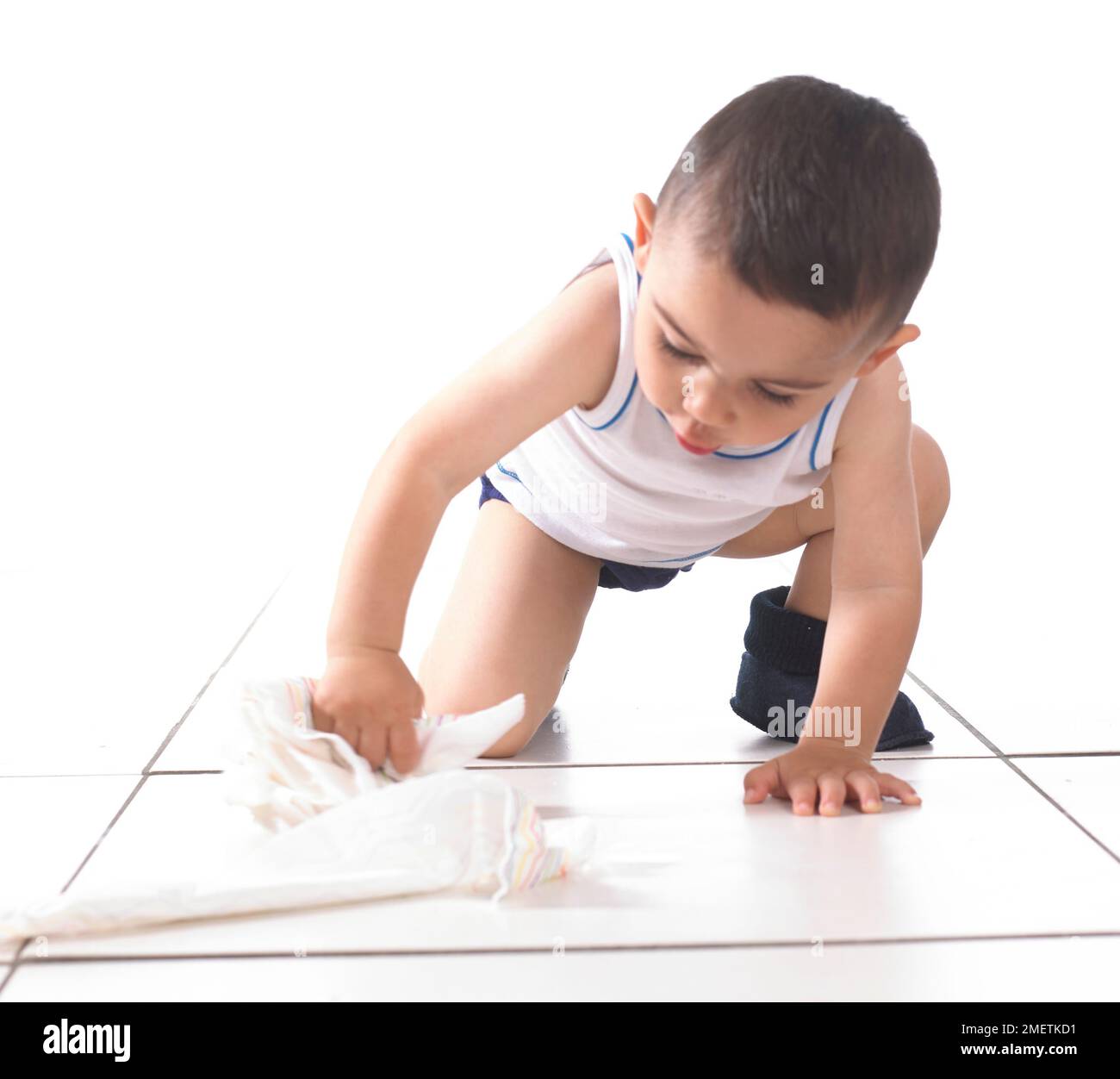 Boy wearing vest and slippers wiping floor with kitchen paper, 15 ...