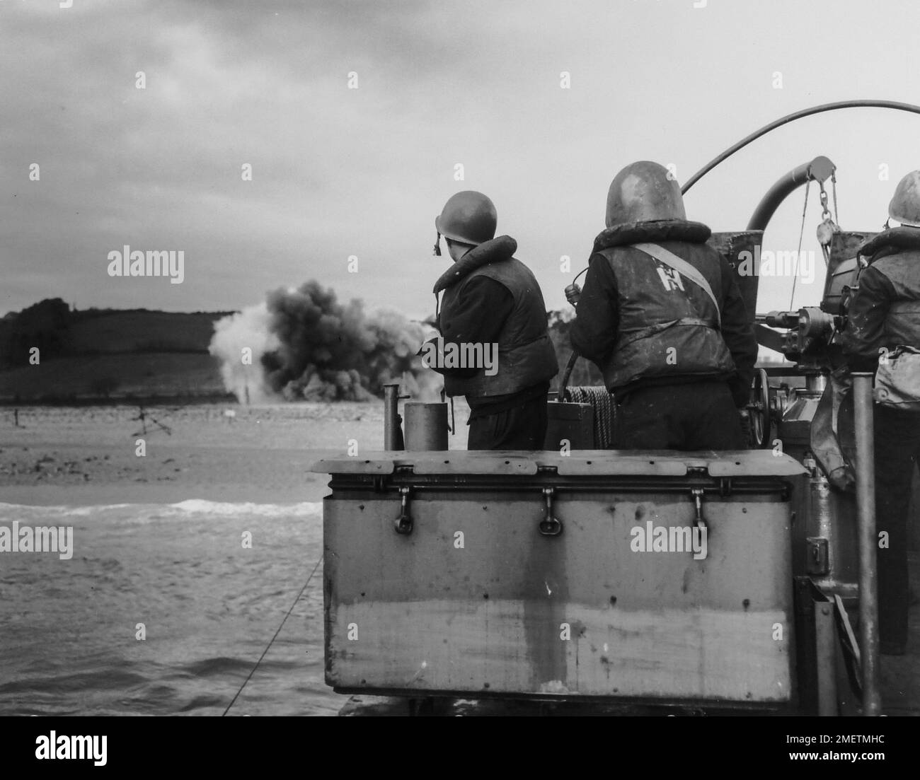 A Coast Guard LCI (Landing Craft Infantry) experiences a near miss from ...