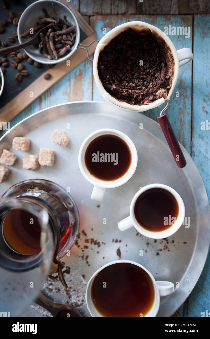 Caffe Touba, coffee in a glass jug, cloth containing coffee grinds and ...