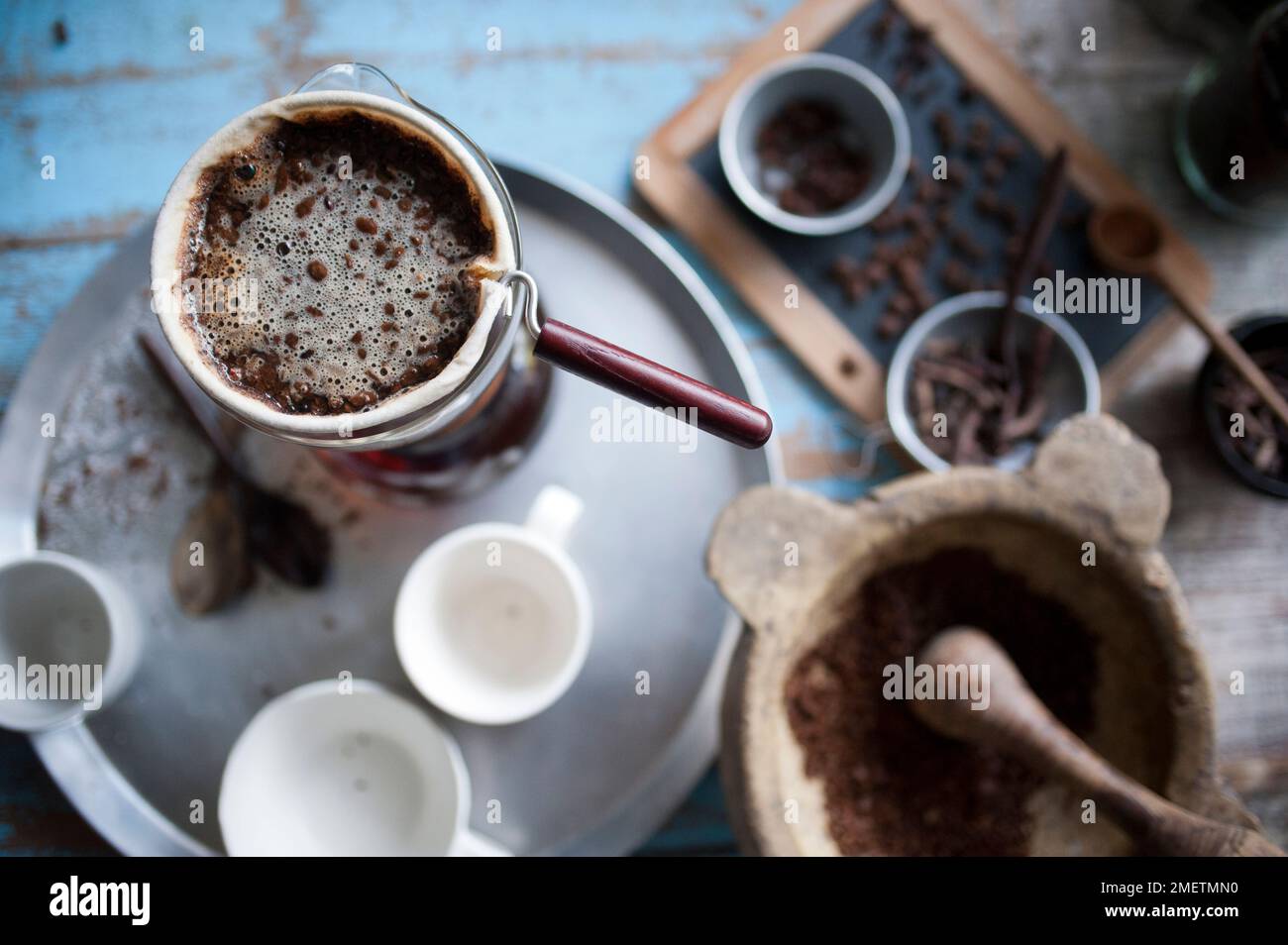 Caffe Touba, coffee draining through a cloth into glass jug Stock Photo ...