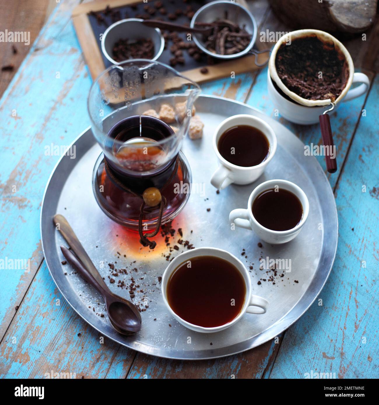 Caffe Touba, tray containing glass jug and three cups of spiced coffee ...