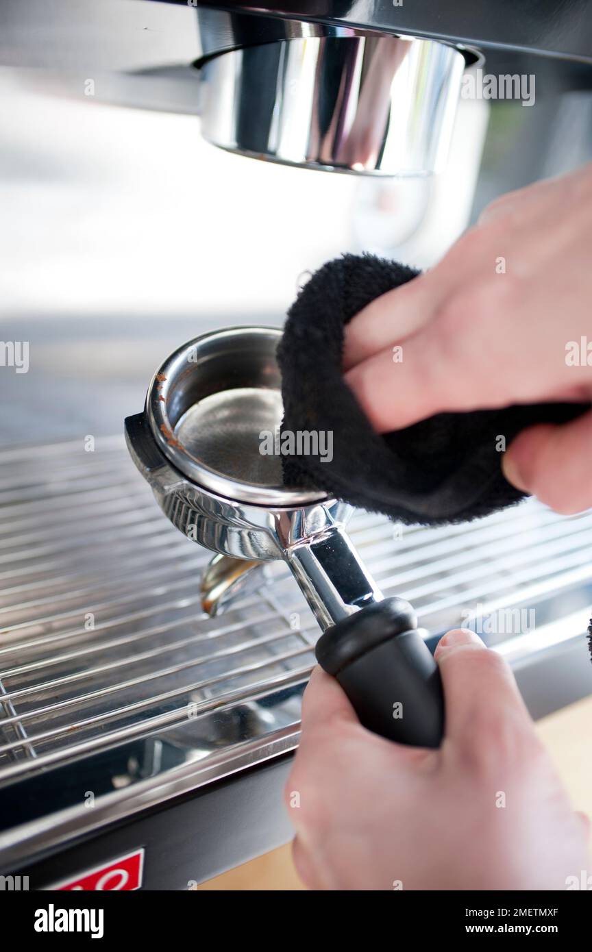 Wiping clean portafilter with dry cloth Stock Photo - Alamy