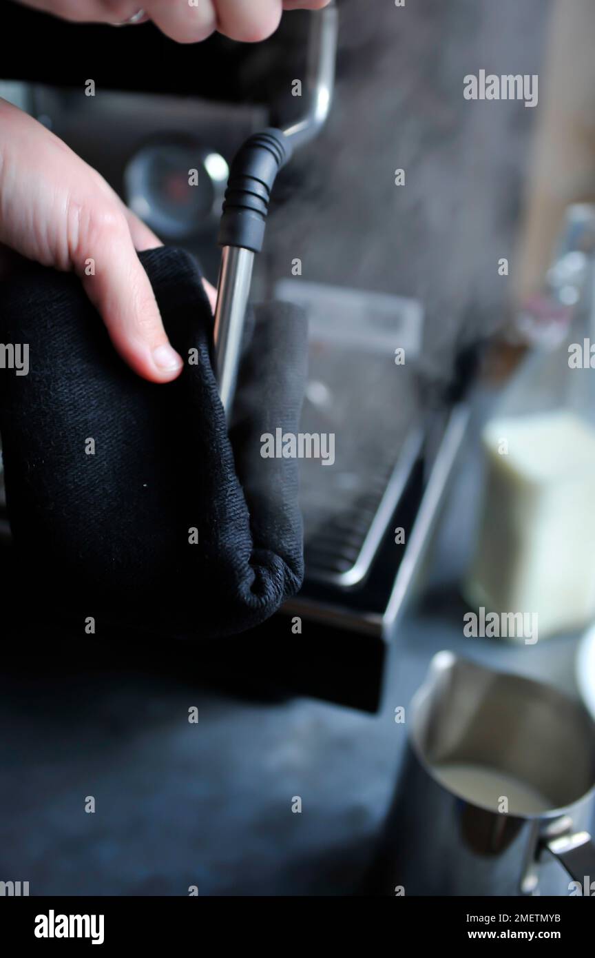 Purging steam from steam arm to clear nozzle Stock Photo - Alamy