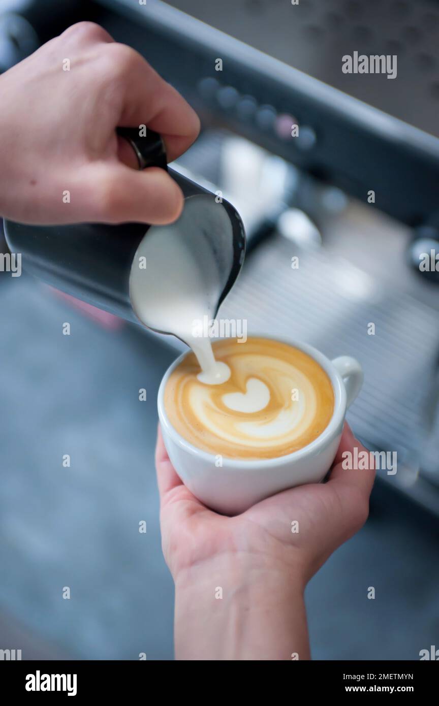 Hand pouring milk coffee on hi-res stock photography and images - Alamy