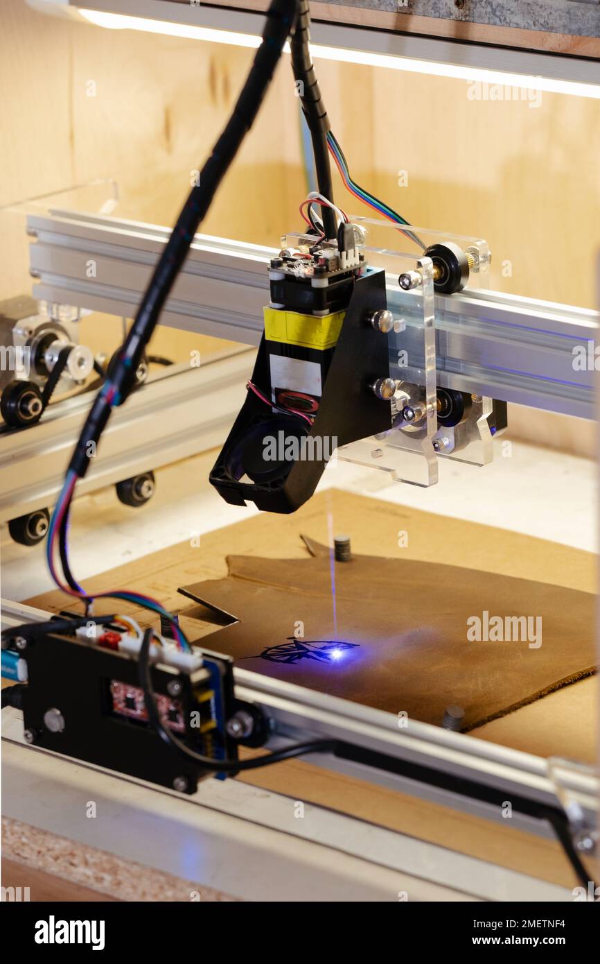 Laser burning on eco leather. Cropped view of the laser machine burning ...