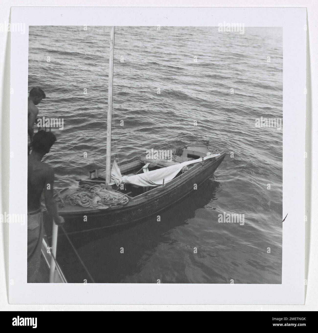 This image captures a small sailboat navigating calm waters, with ...