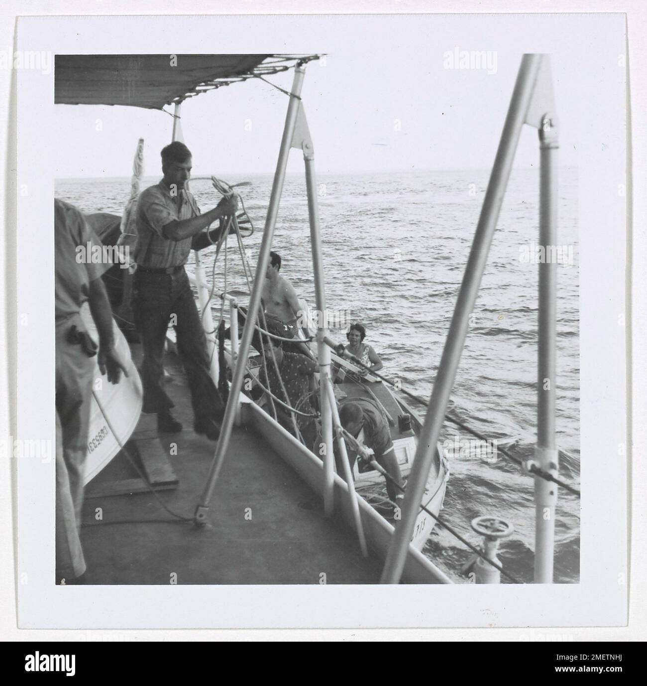 People disembark from a small boat, likely after a maritime operation ...