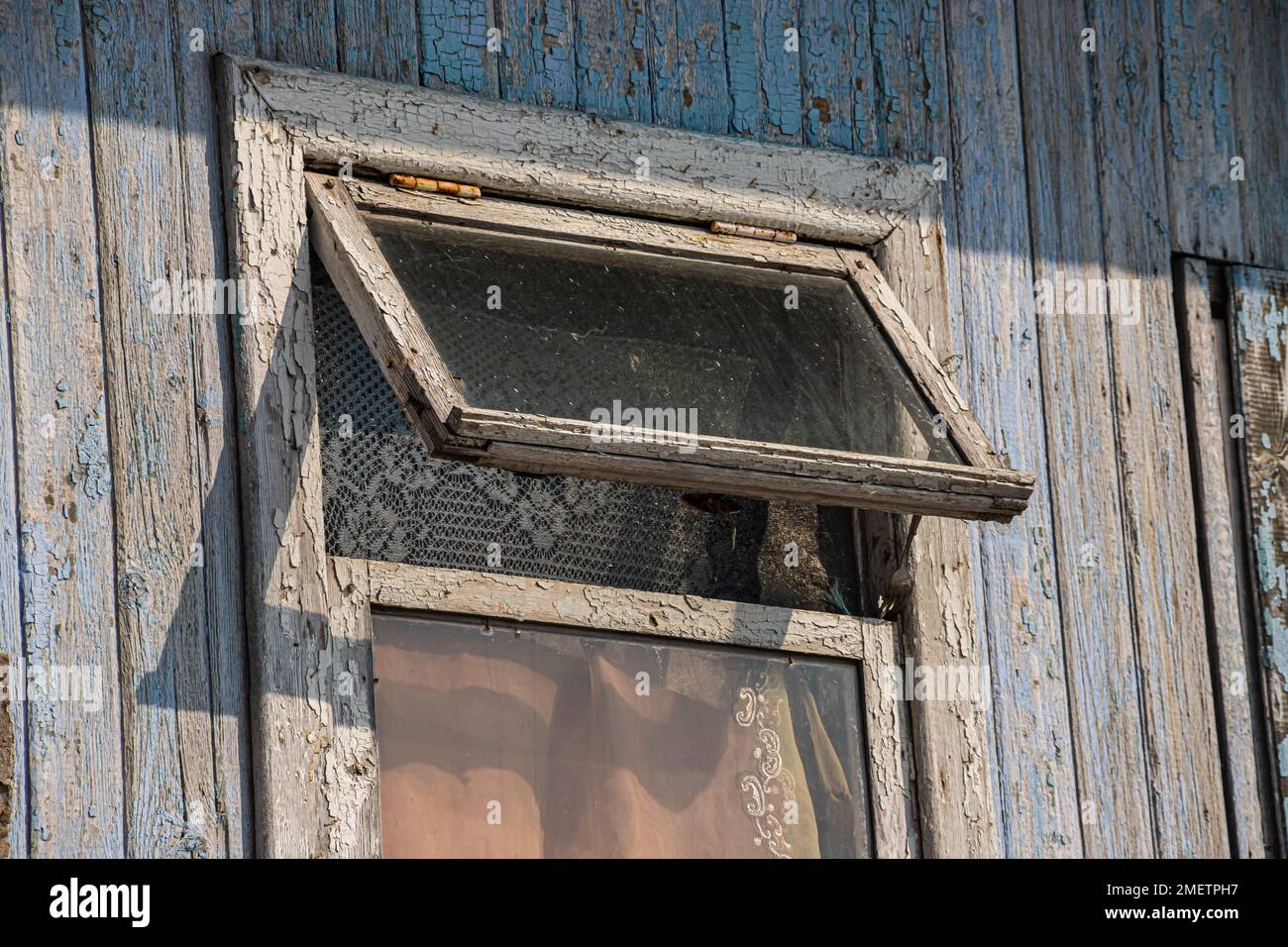 The window of the old wooden log house on the background of wooden ...