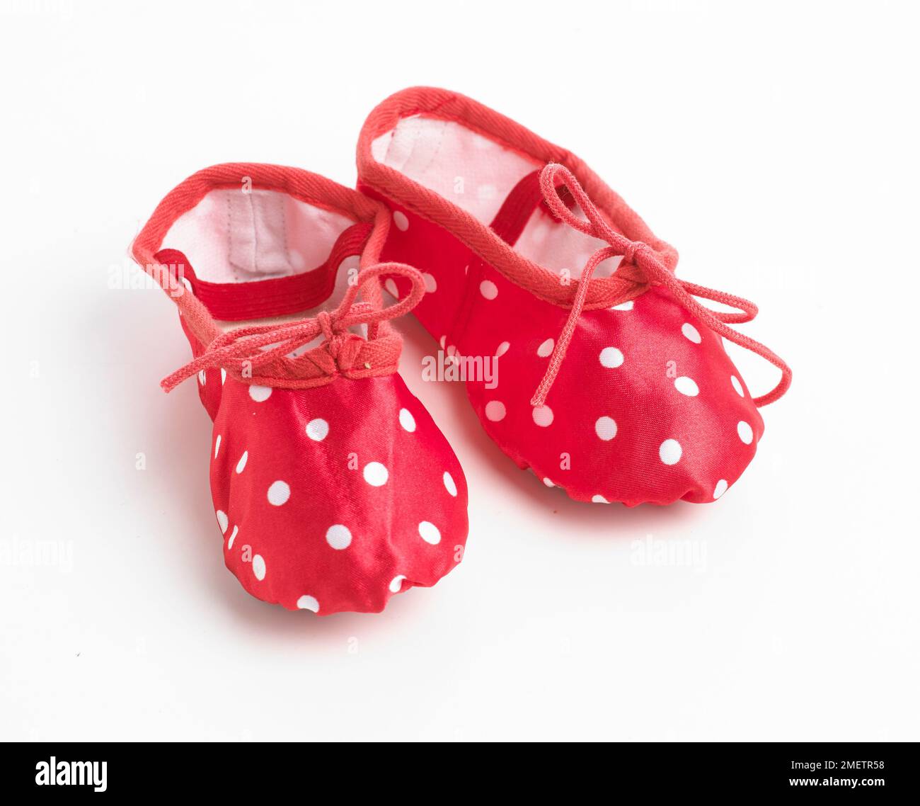 Red spotty fabric children's shoes Stock Photo - Alamy