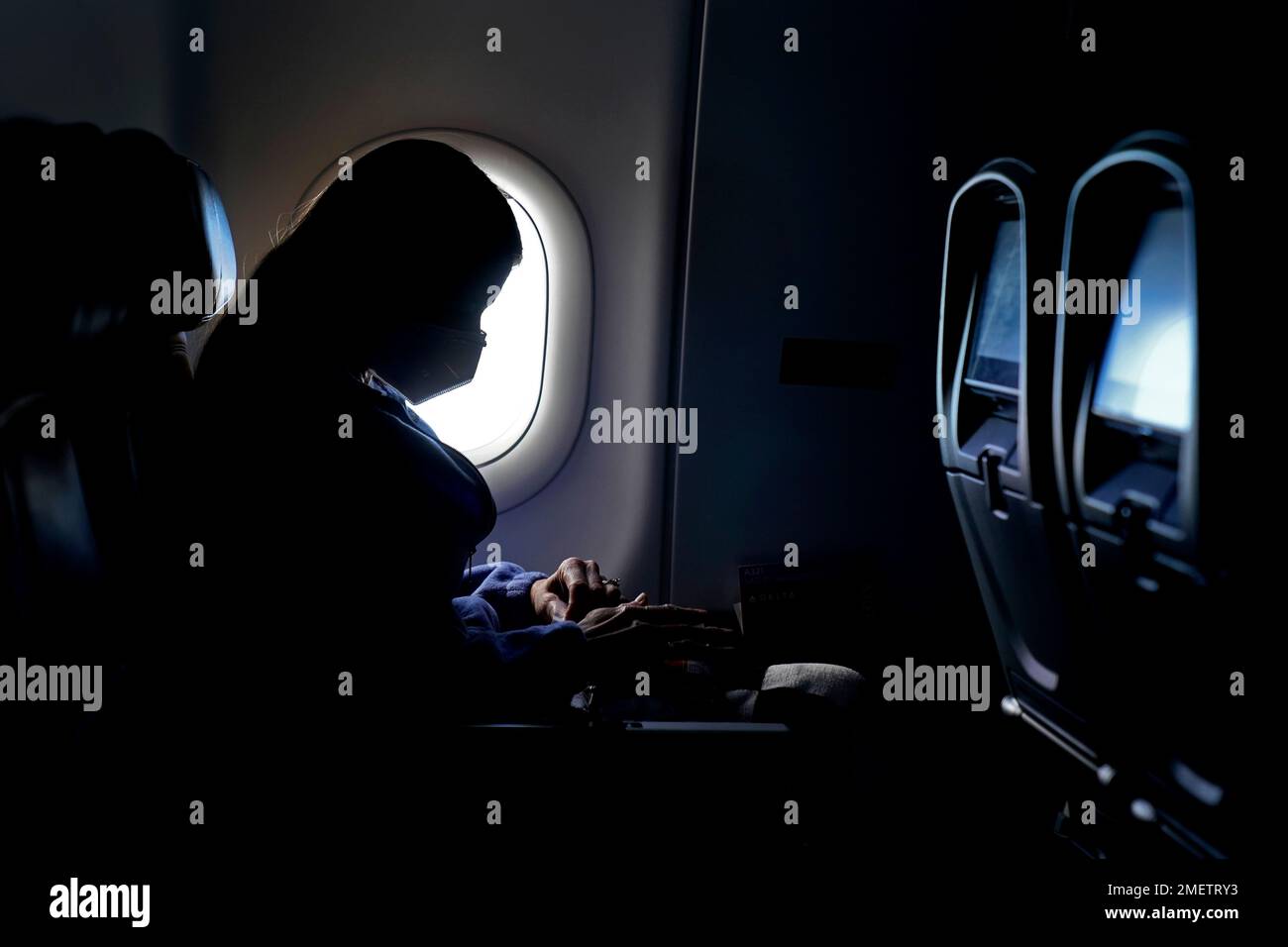 FILE - In this Wednesday, Feb. 3, 2021, file photo, a passenger wears a ...