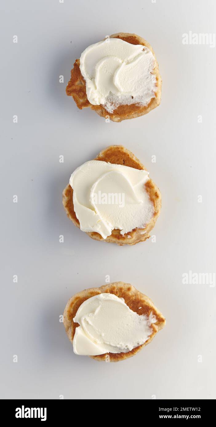 Mixed spice drop scones topped with cream cheese Stock Photo - Alamy