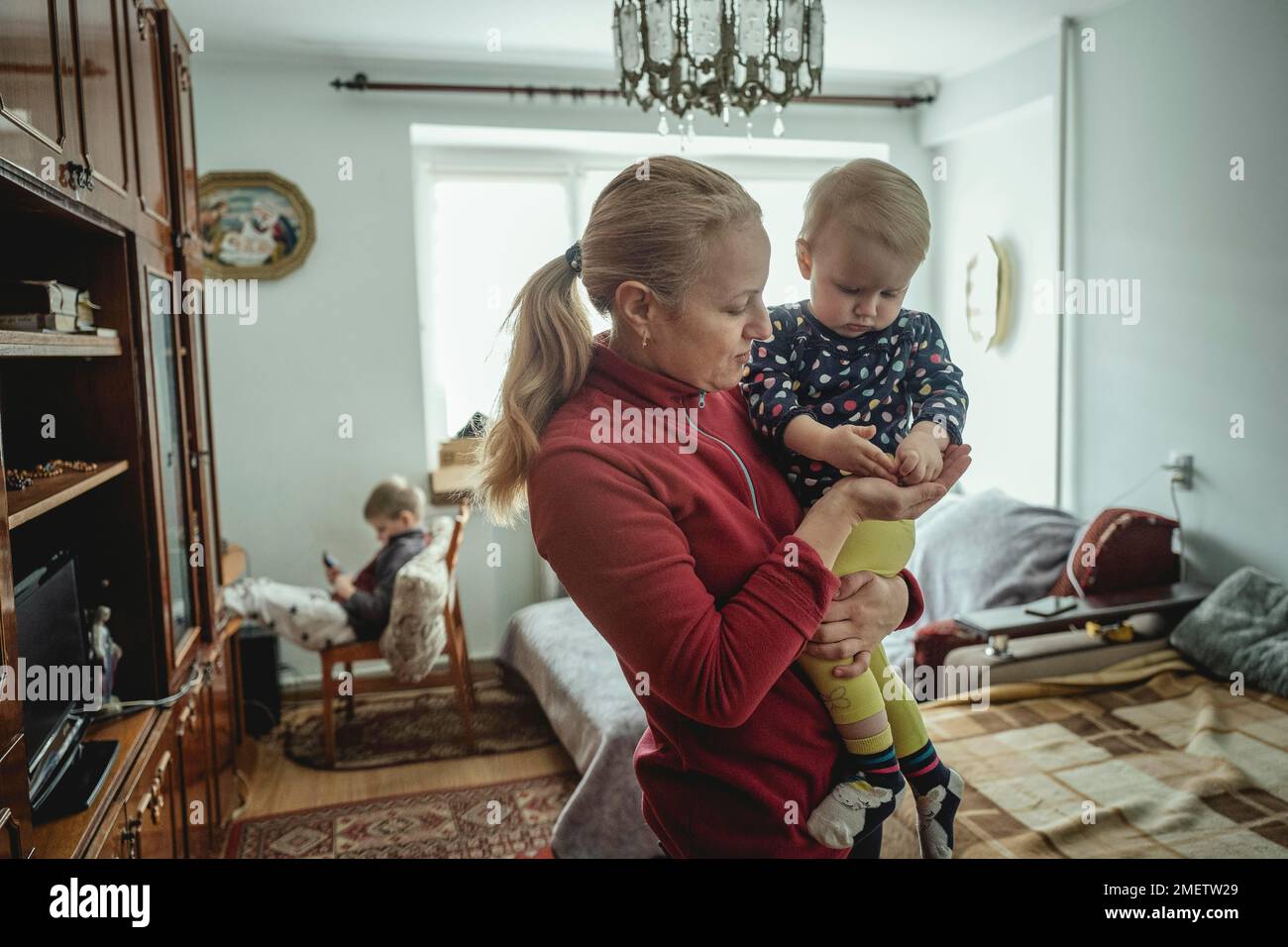 A mother with her youngest daughter, her man and her eldest are at the ...