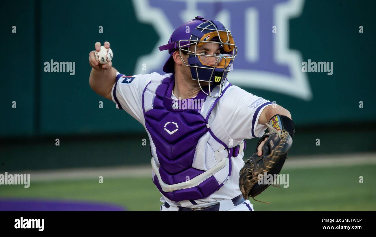 TCU catcher Zach Humphreys (10) throws during warm ups between innings ...