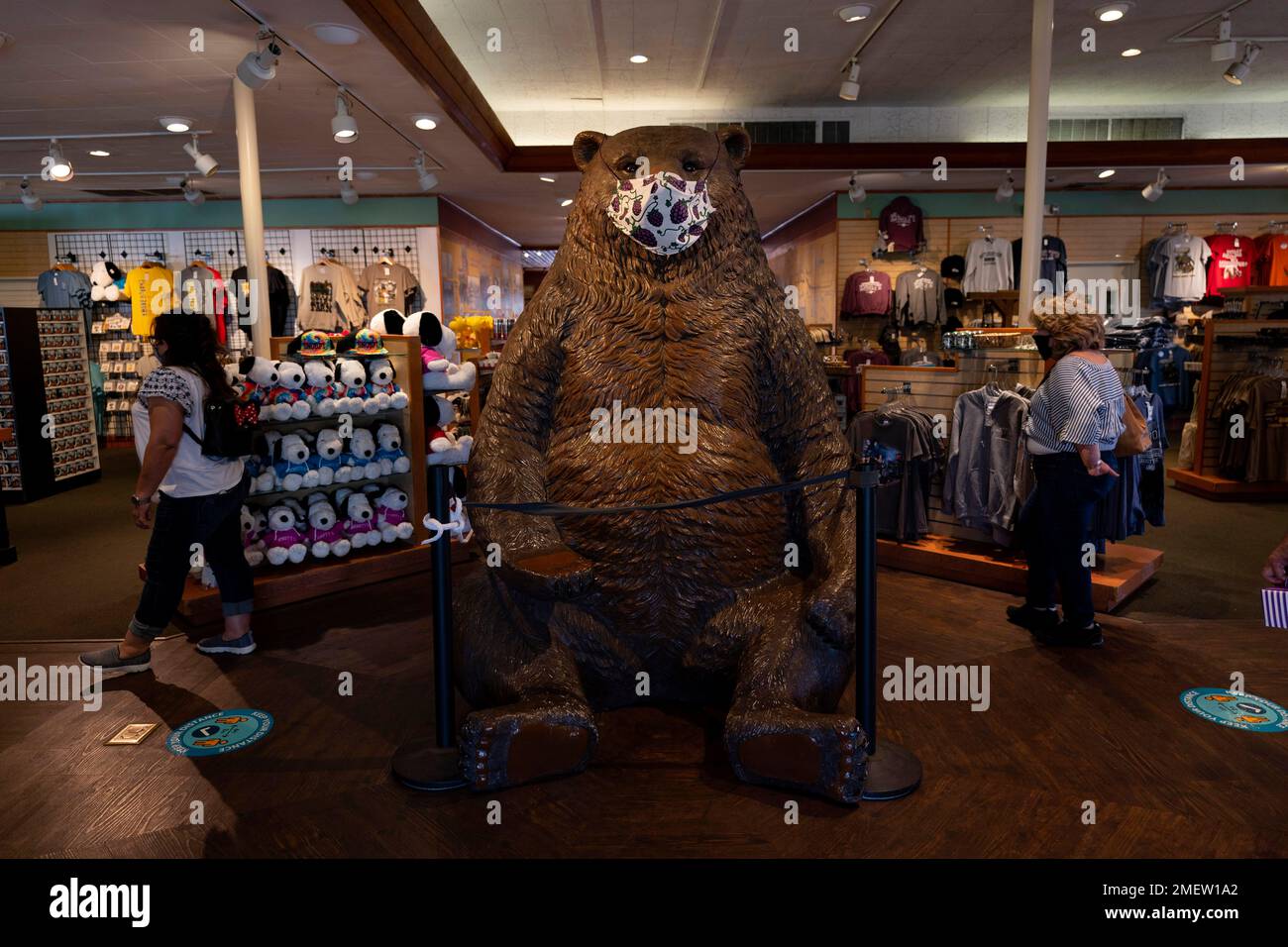 A large mask is put on a bear statue at a gift shop during the Knott's ...