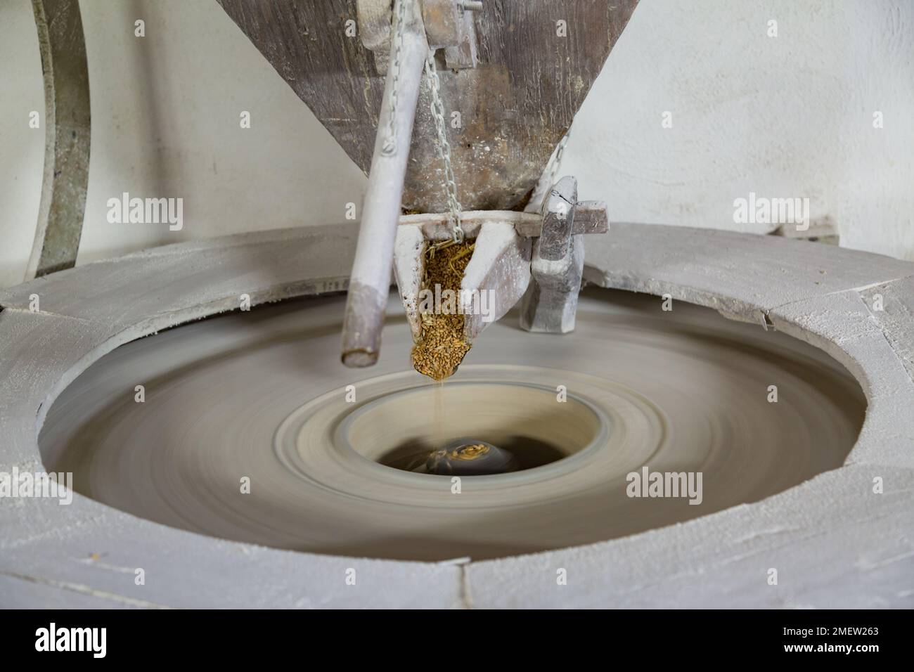 Wheat falling onto water-driven grindstone at Molino Grifoni, mill ...