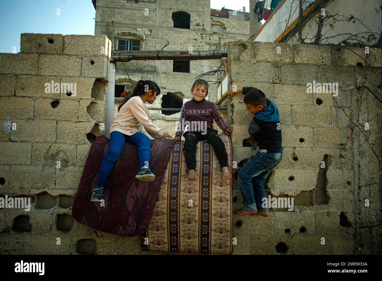 Palestinian children play outside their homes in a poor neighborhood in Beit Lahia in the ...