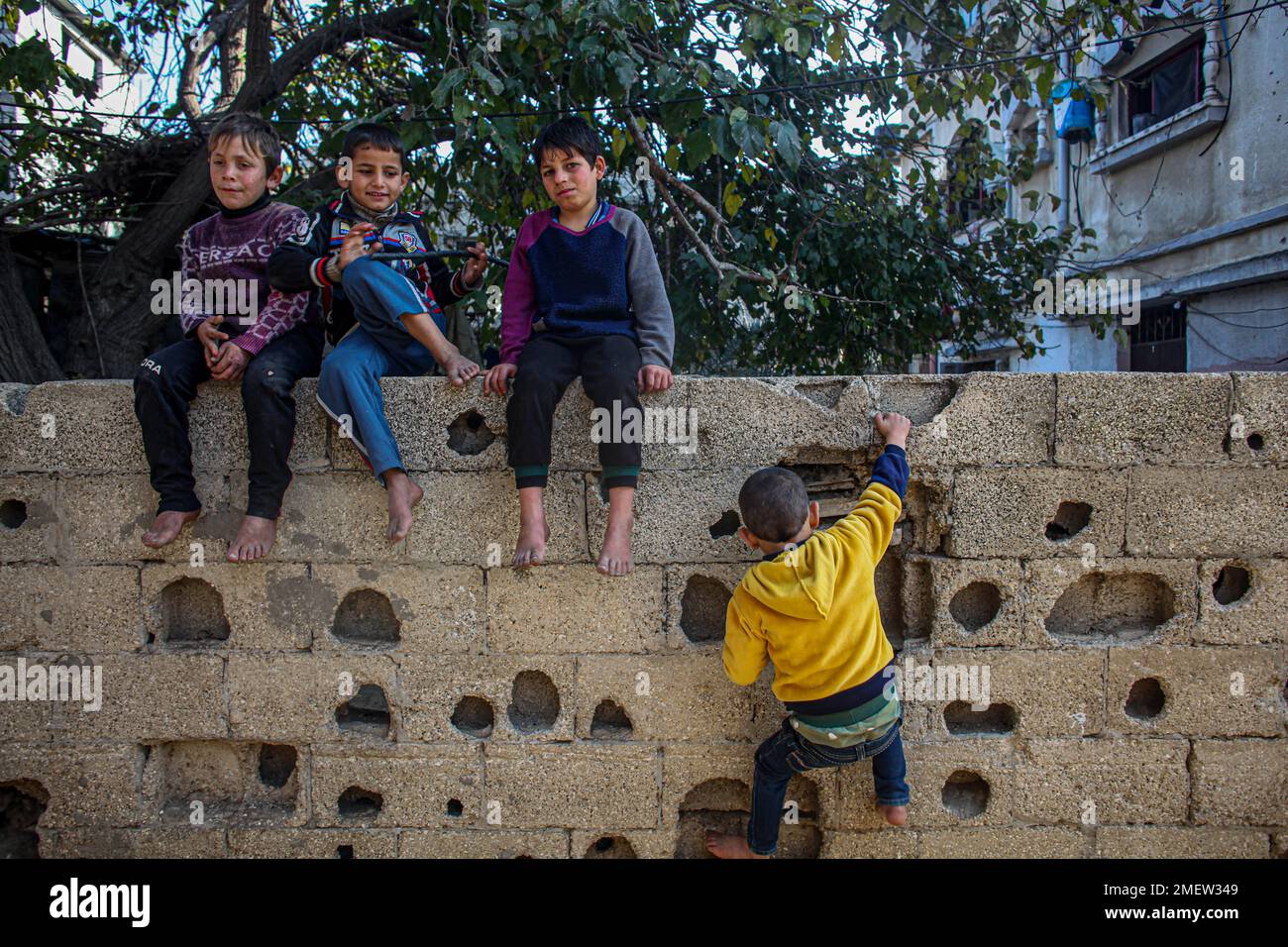 Palestinian children play outside their homes in a poor neighborhood in ...
