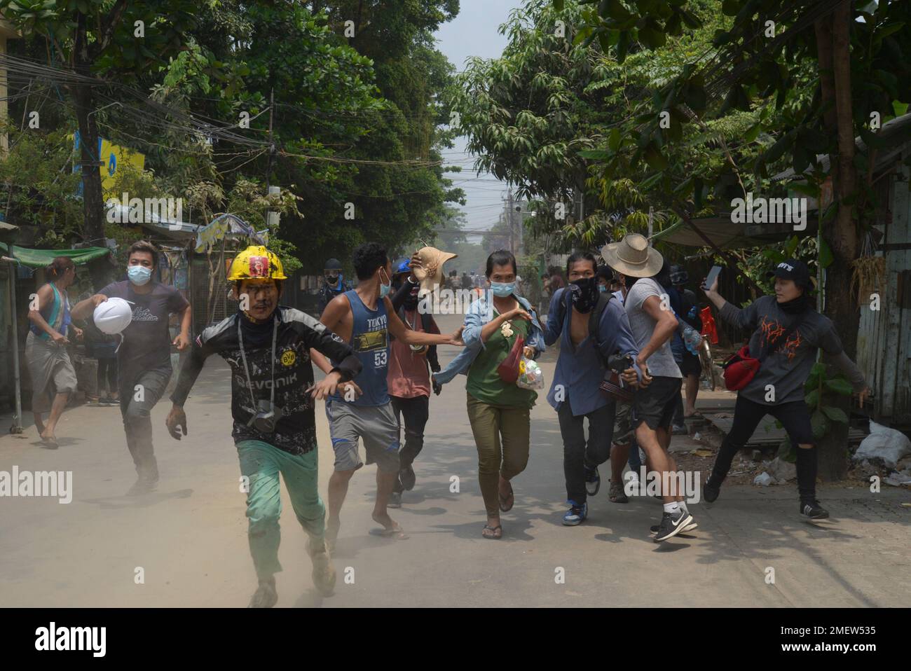 Anti-coup protesters run to avoid the military during a demonstration ...