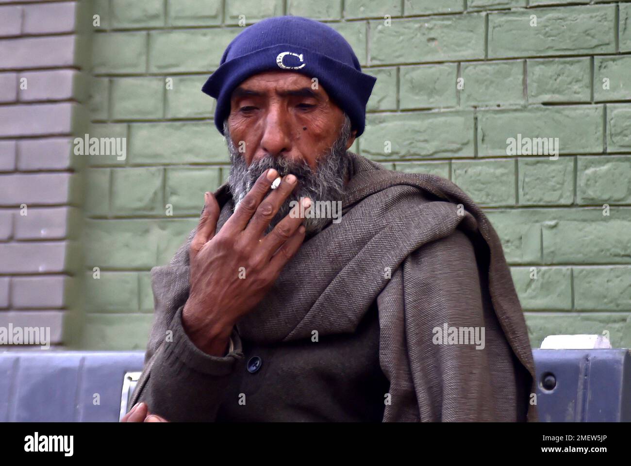 Peshawar. 24th Jan, 2023. A man smokes a cigarette in northwest ...