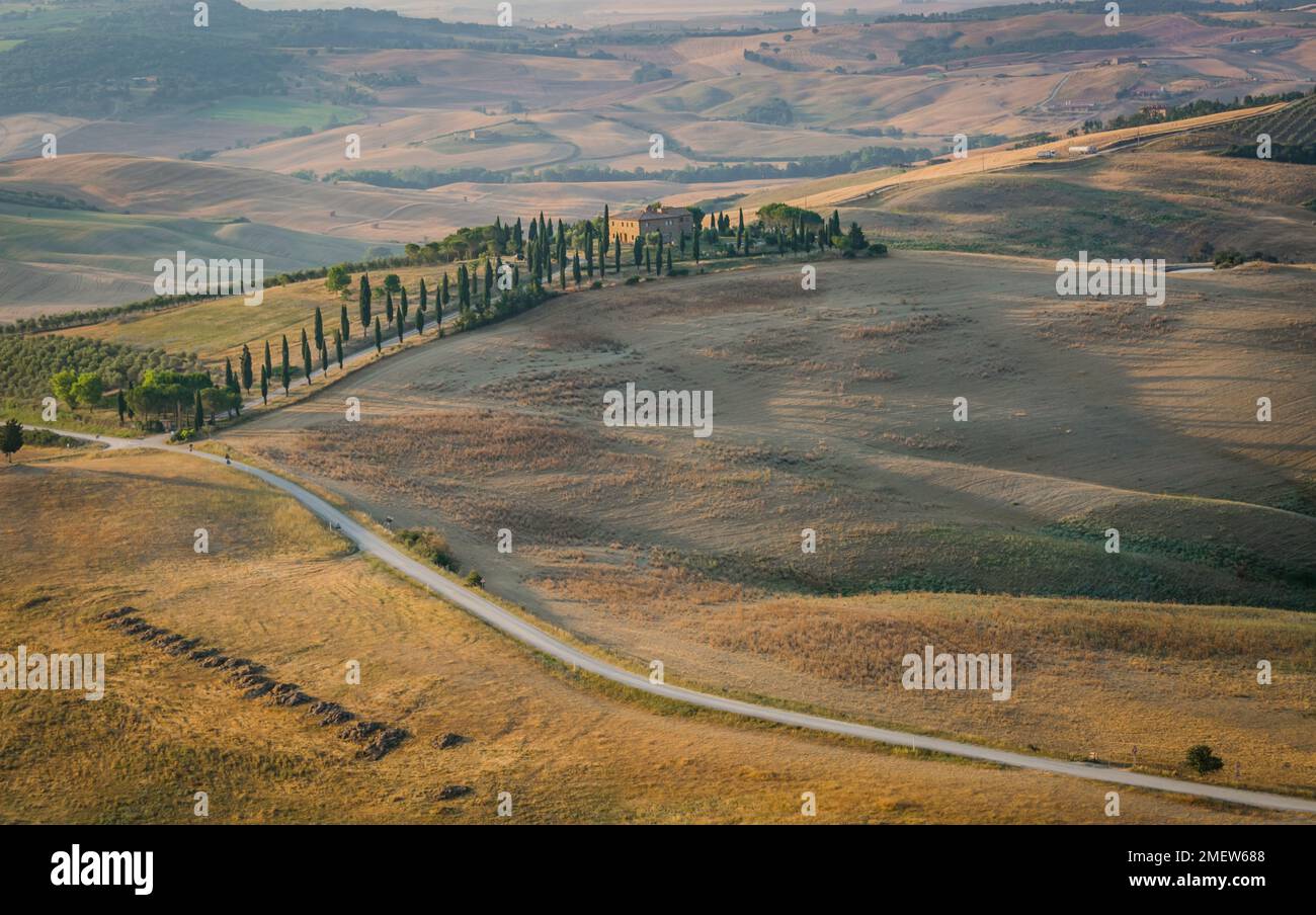 Aerial view of Tuscan landscape with rolling hills and white road ...