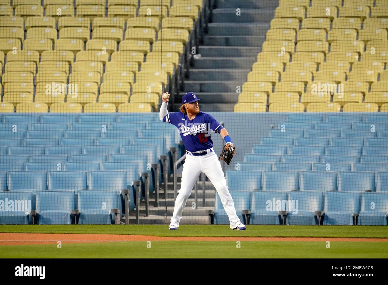 Los Angeles Dodgers third baseman Justin Turner warms up in an empty ...