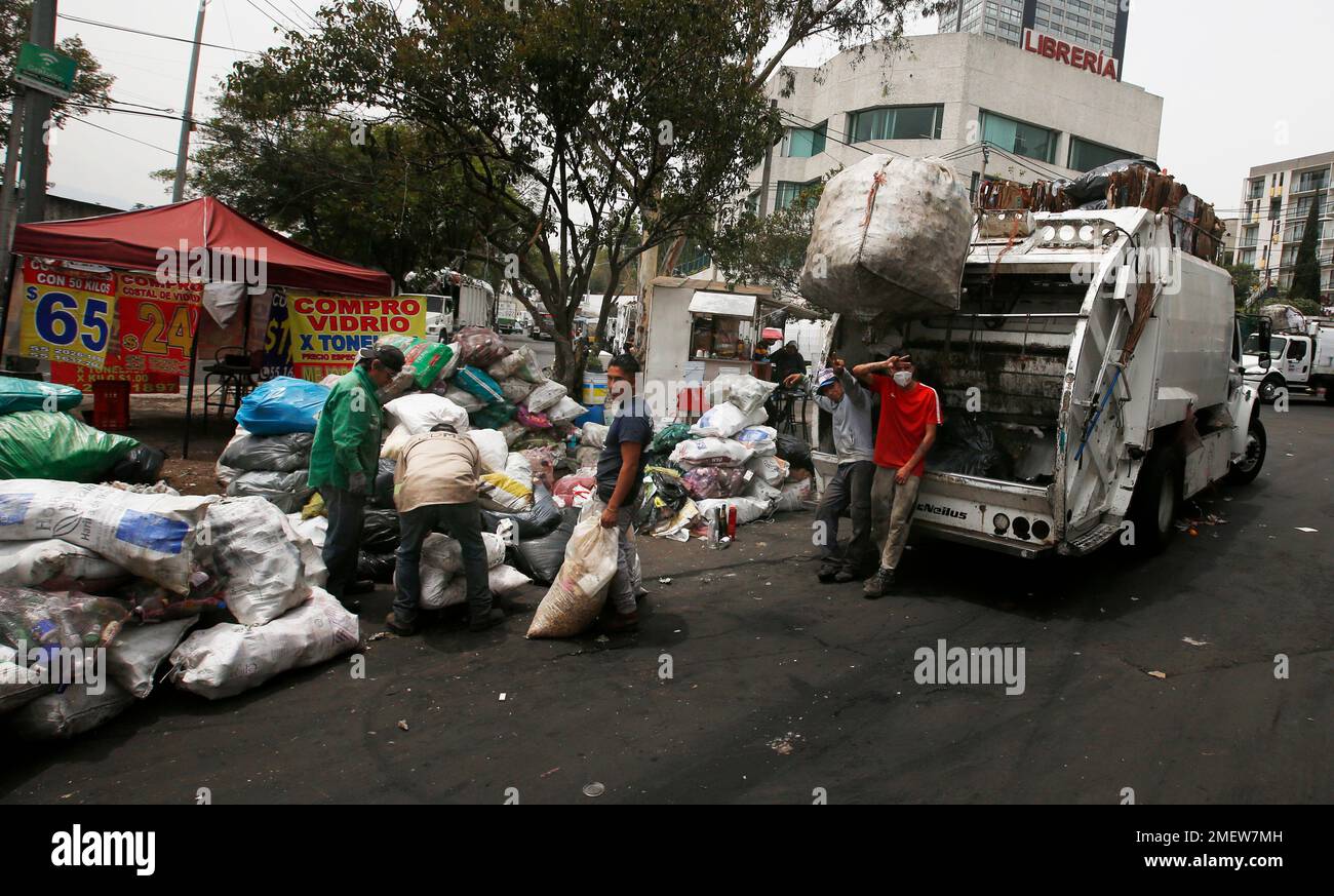 Trash pickers sort items collected from garbage in Mexico City, Monday ...