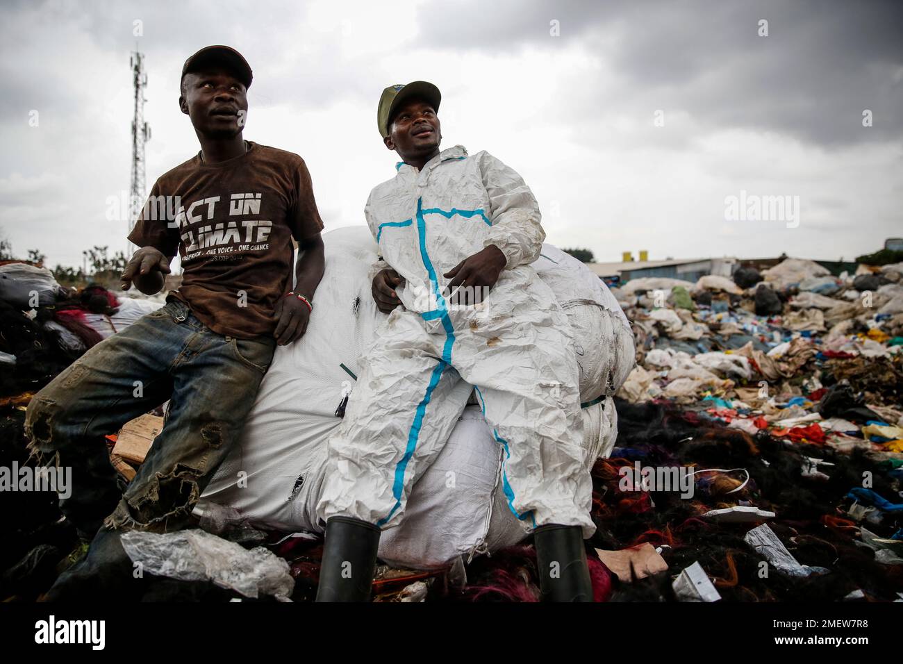 Men scavenge recyclable materials at a garbage dump in Dandora, the ...