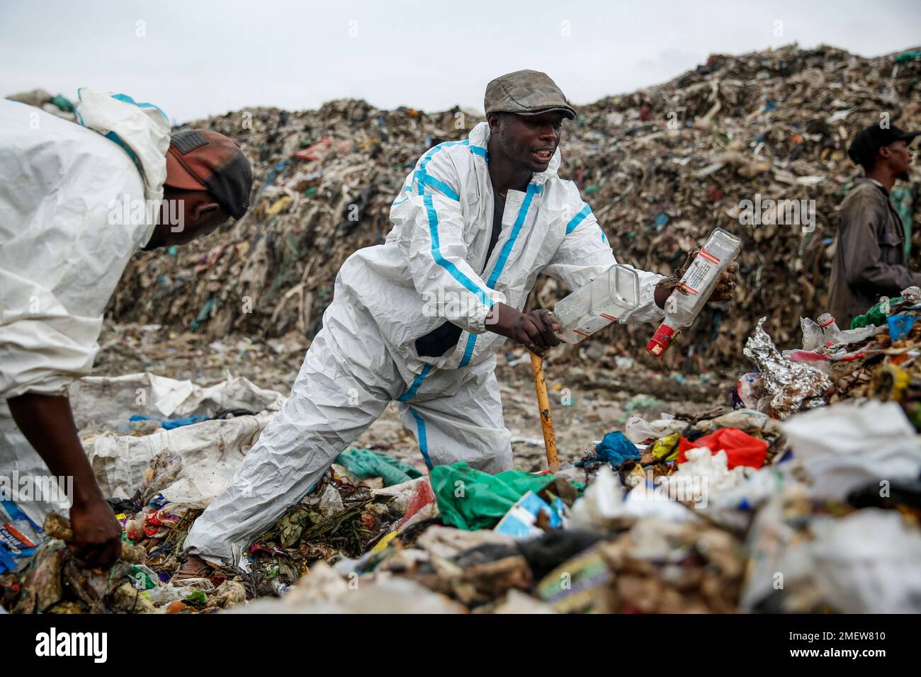Duncan Wanjohi, center, and Kelvin Kimani, left, scavenge recyclable ...